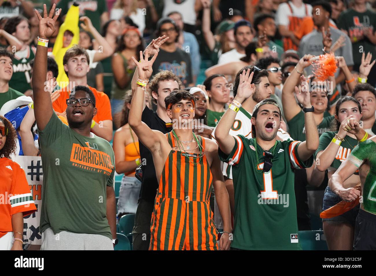 Miami fans cheer during the second half of an NCAA college football ...