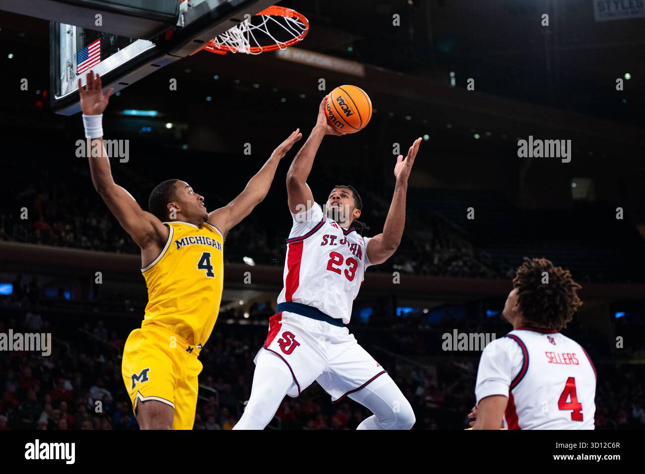 St. John forward Bryce Hopkins (23), defended by Michigan guard Nimari ...