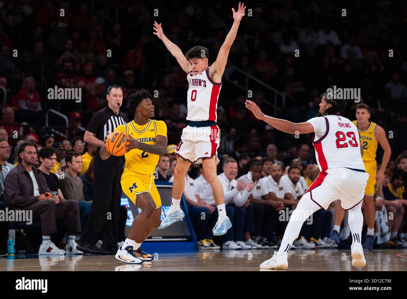 St. John guard Dylan Darling (0) leaps to defend against Michigan guard ...