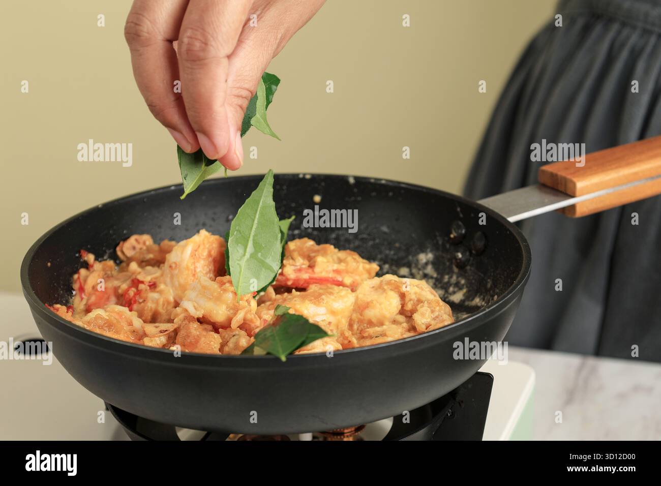 Female hand put curry hi-res stock photography and images - Alamy