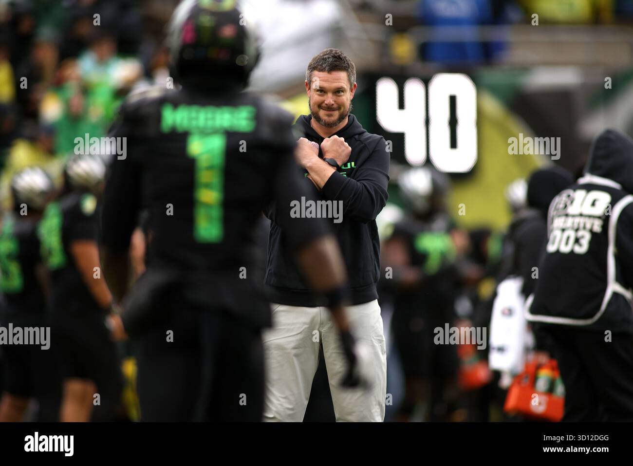 Oregon head coach Dan Lanning greets Oregon wide receiver Dakorien ...