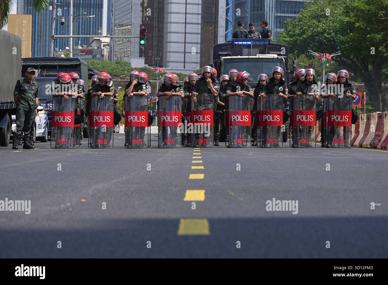 Federal Reserve Unit (FRU) police officers block a road during a ...