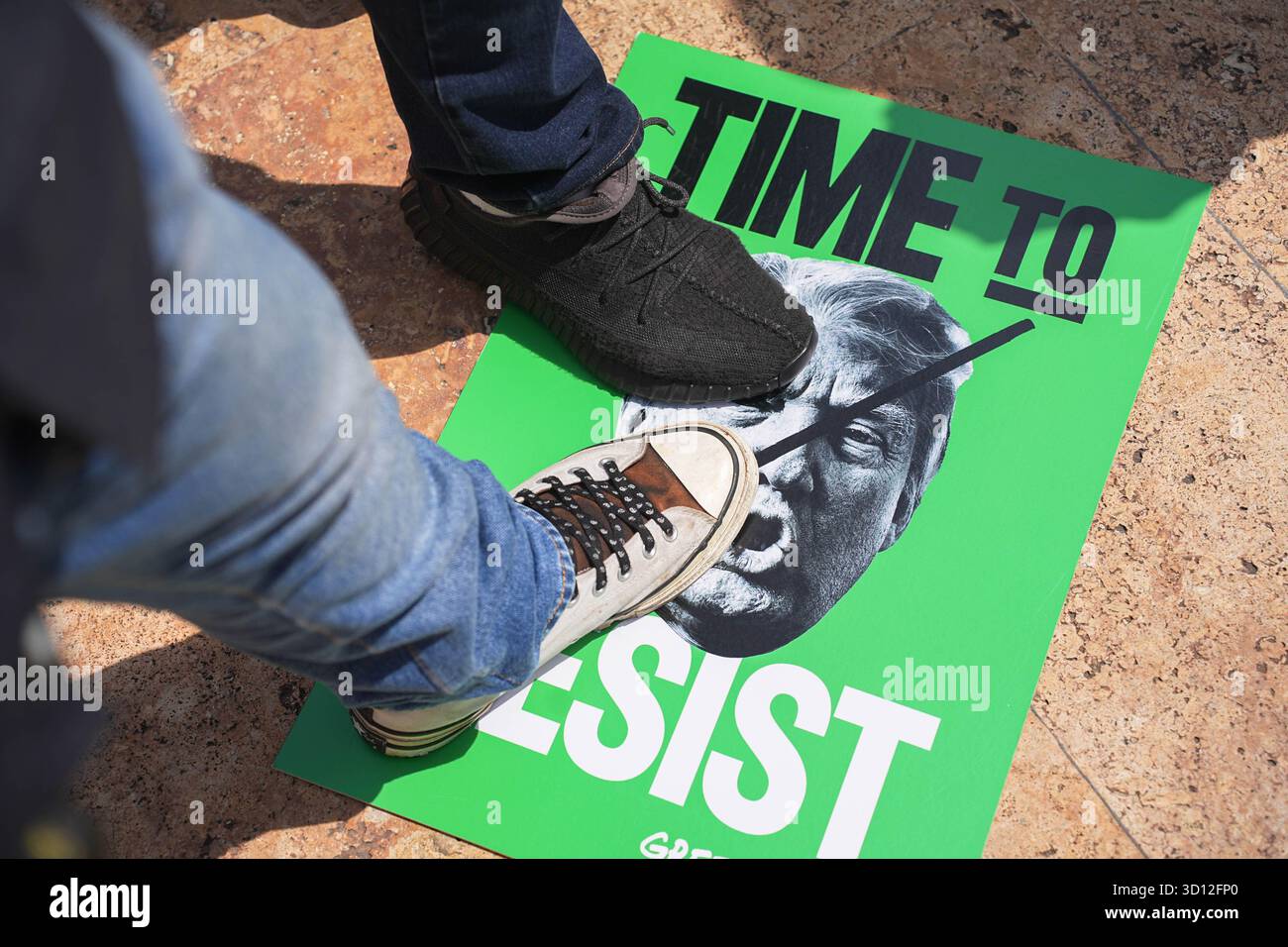 Protesters steps on a poster of U.S. President Donald Trump during a ...