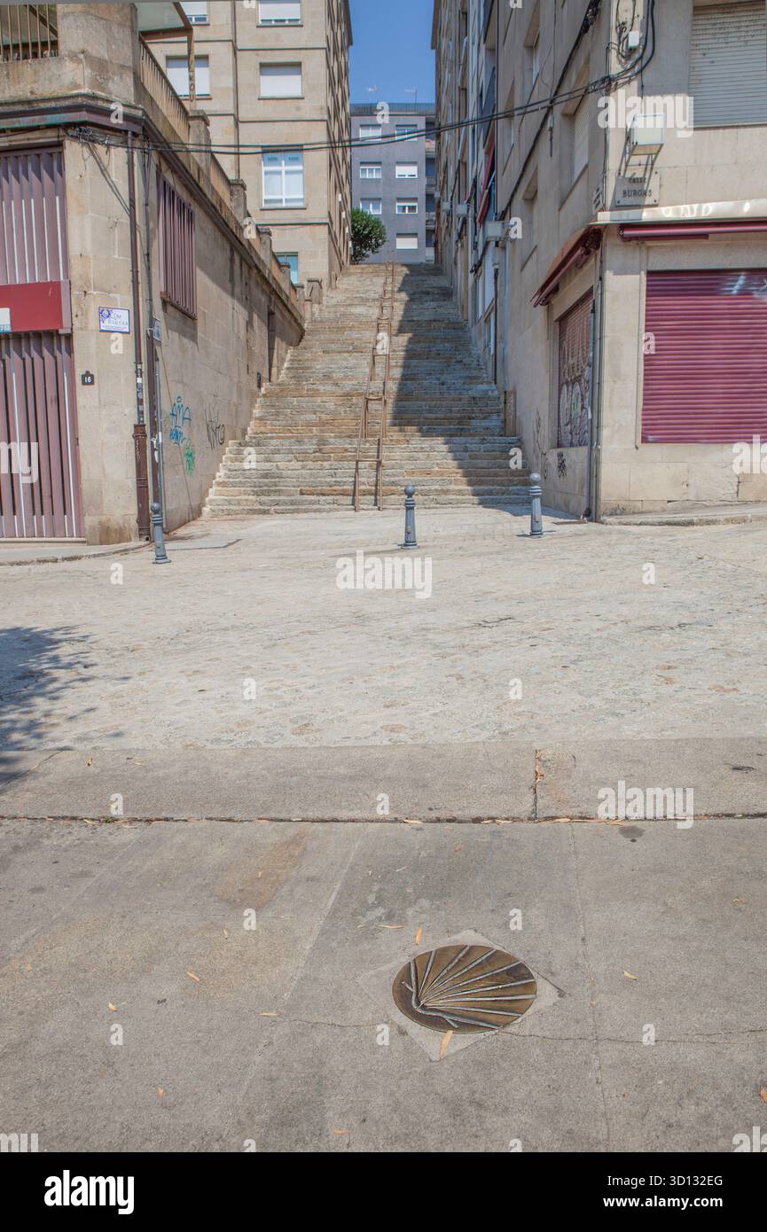 Orense, Spain - August 24th, 2025: Metal scallop shell on the ground ...