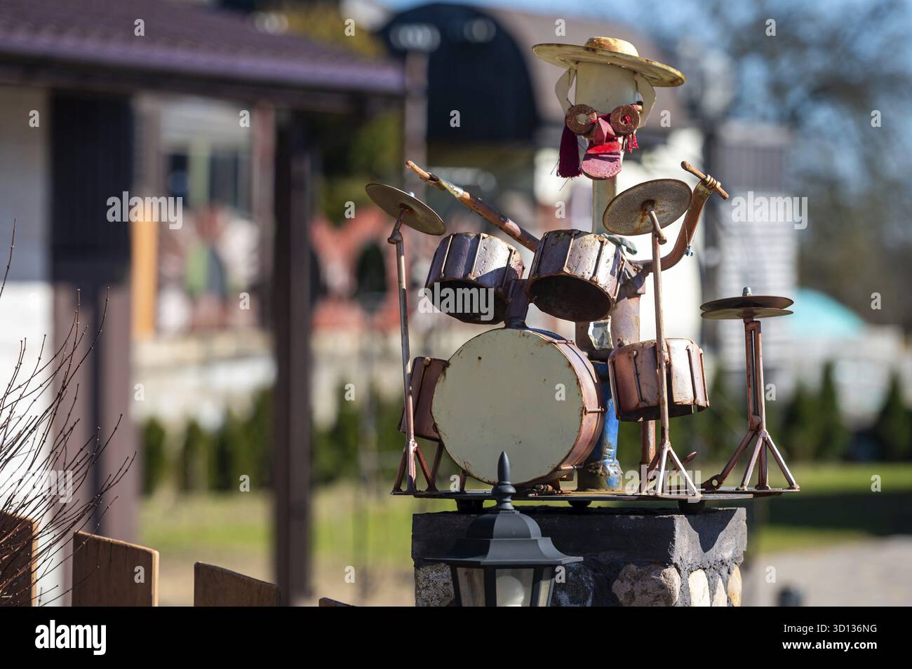 Unique metal sculpture of drummer figure playing in an outdoor setting ...