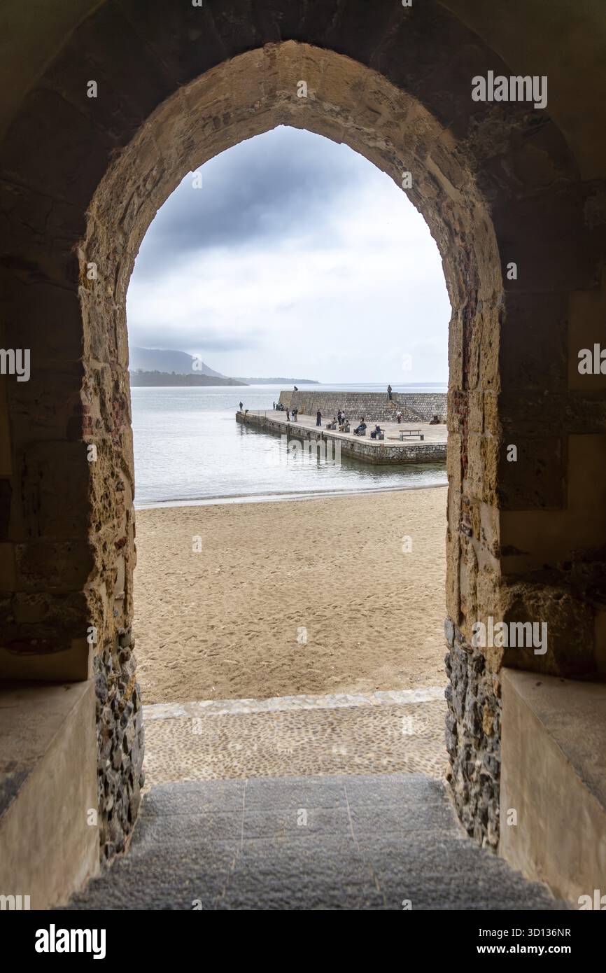 Cefalu - Sizilien - Italien - 03-24-2025: View through a historic stone ...