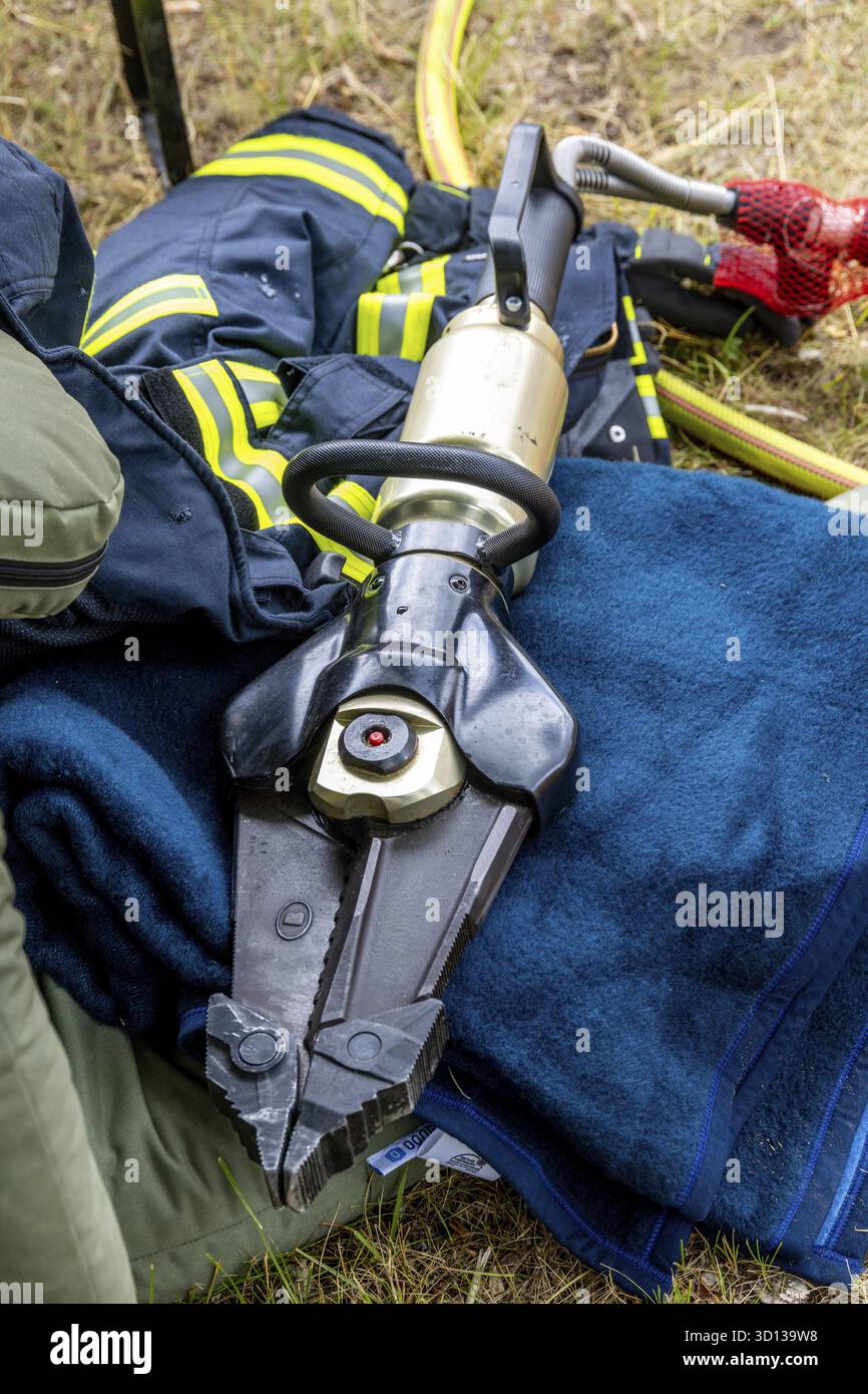 Close-up view of a firefighter's hydraulic rescue tool, crucial for ...