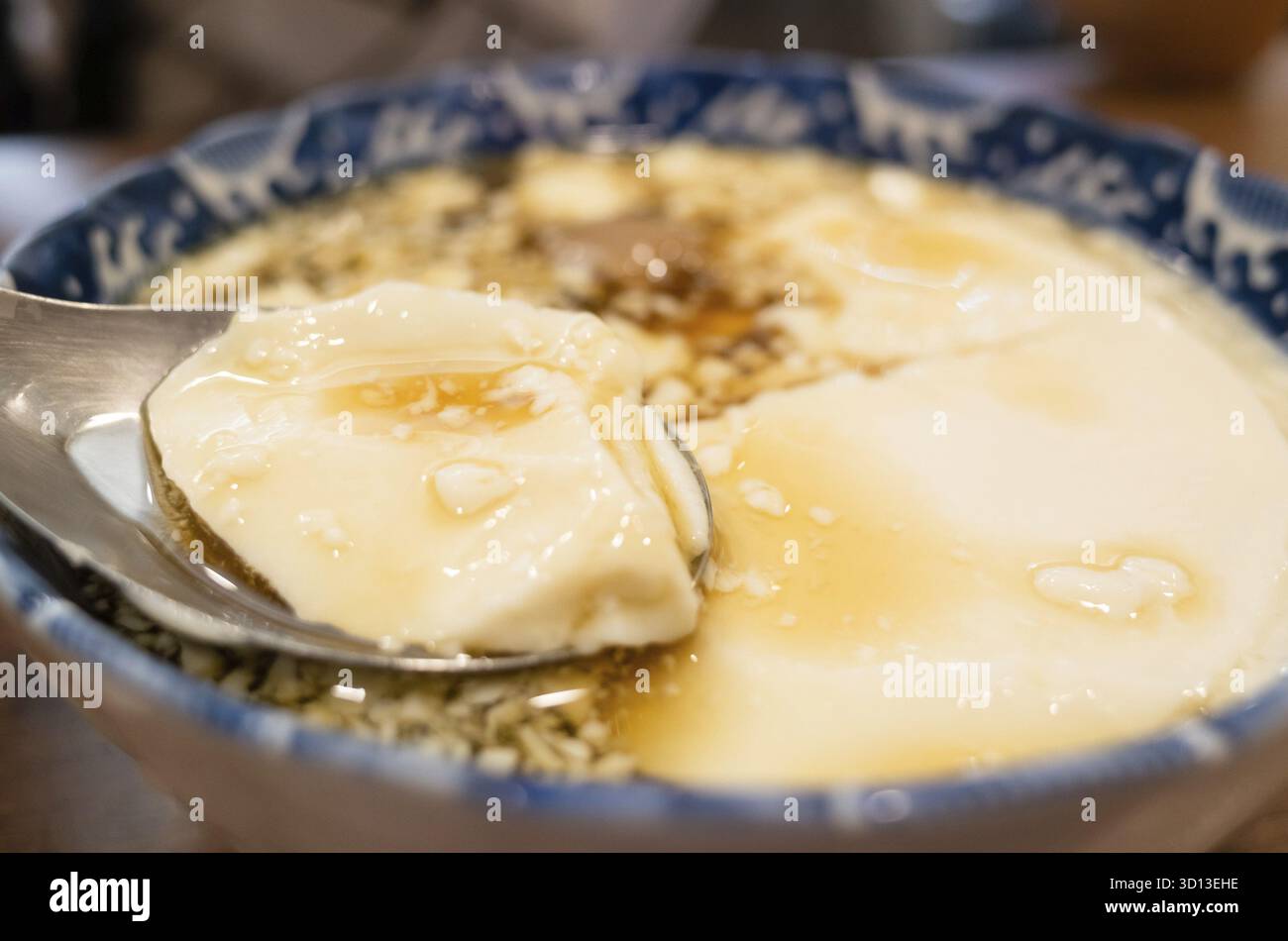 Eating famous Taiwan snacks of iced tofu pudding Stock Photo - Alamy