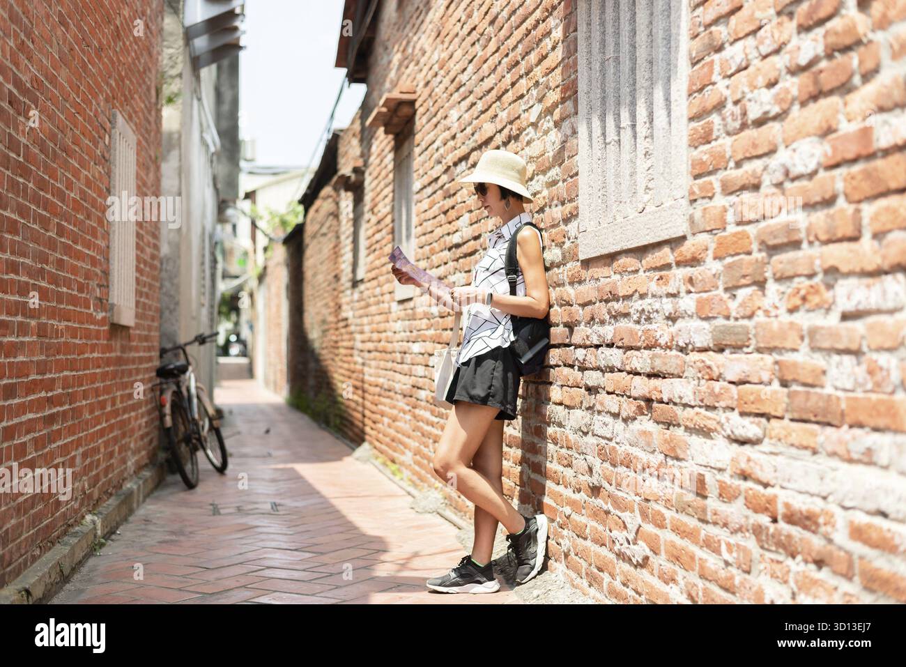 Traveling Asian woman check the map in the old street at Lukang town at ...