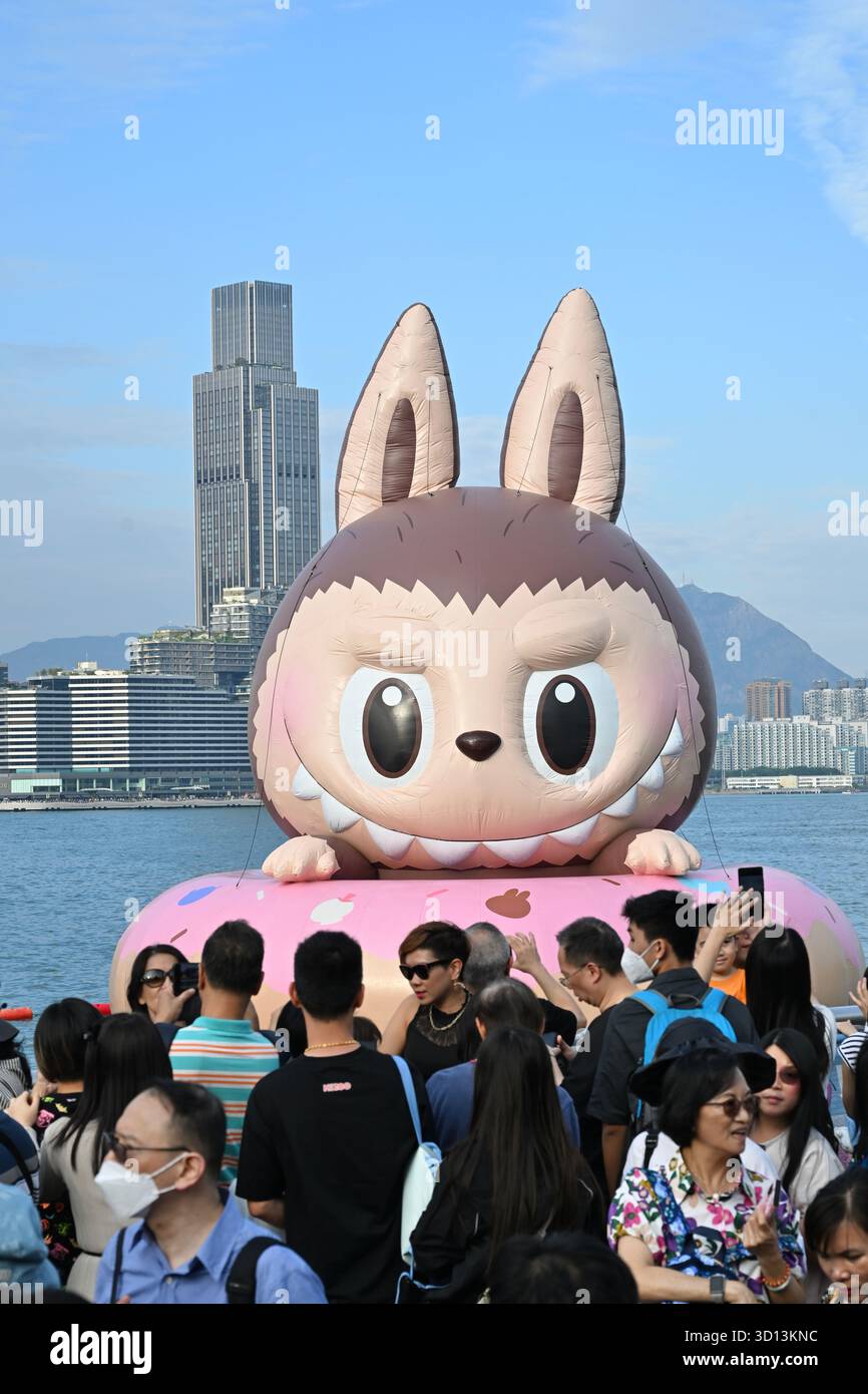 People taking photo with Labubu, a floating inflatable sculpture at the ...