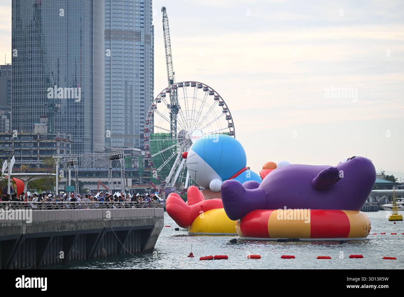 Floating inflatable sculpture of Doreamon, Elmo and Grimes at the ...