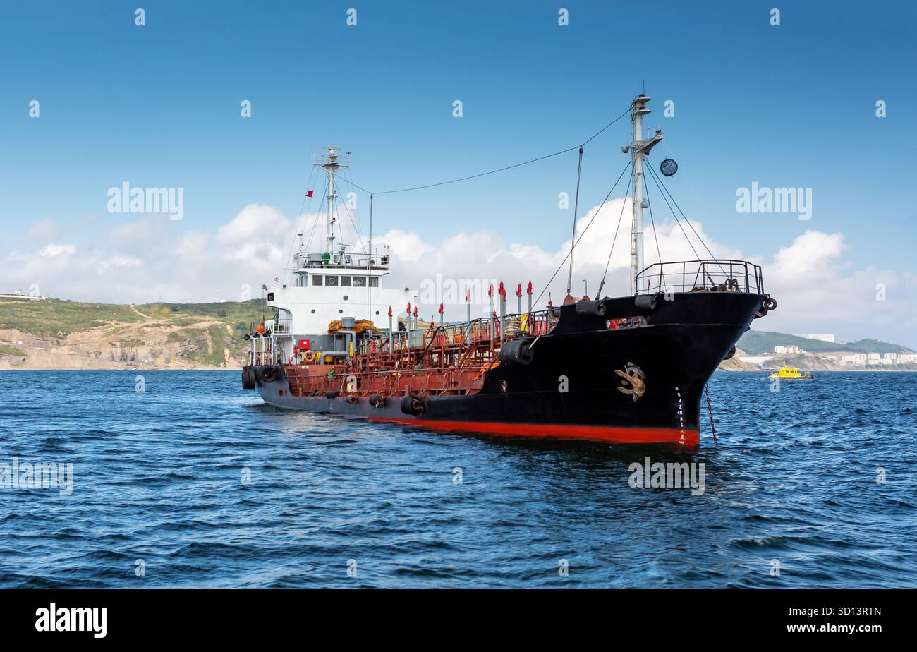 Ship in raid. Industrial bulk carrier tanker anchored in blue sea ...