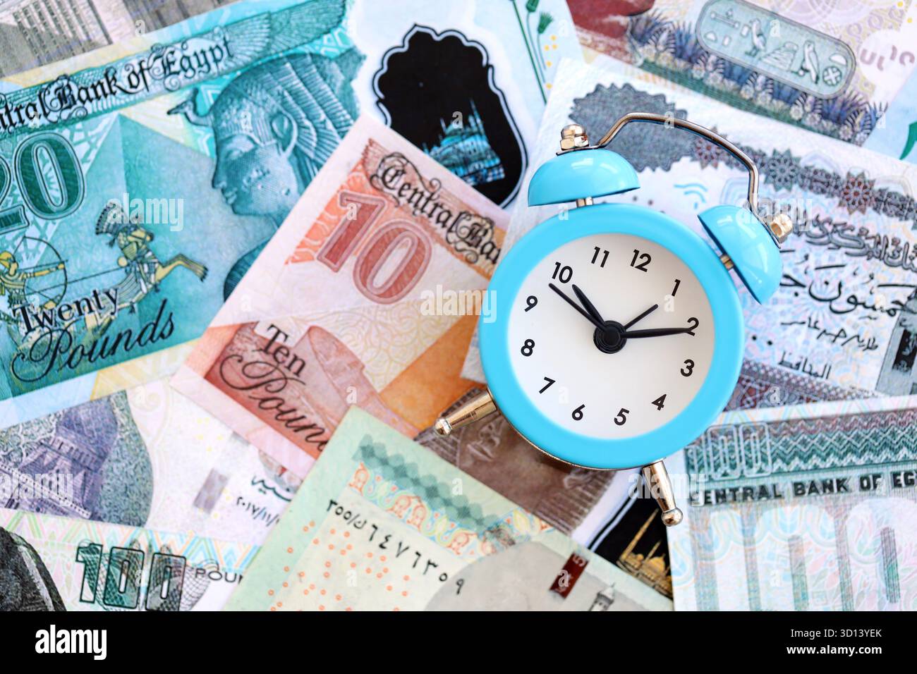 Egyptian pound currency money bills and alarm clock close up. The ...