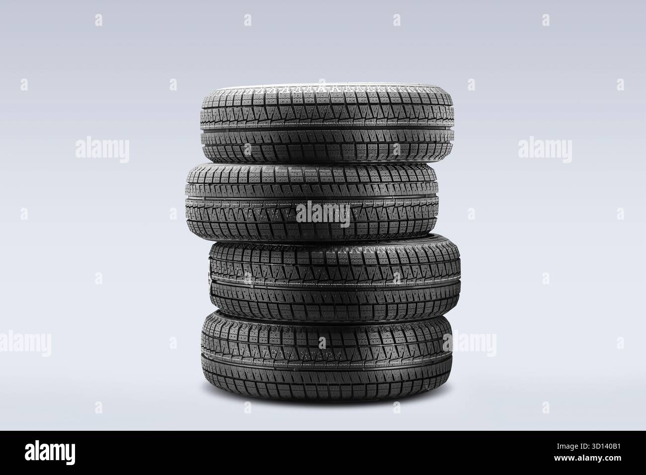 Four winter tires are stacked together, ready for off-season storage ...