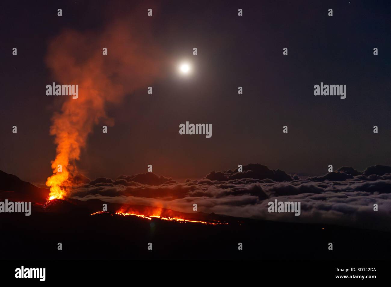 Glowing eruption at night, over a sea of clouds, lit by the Moon light ...