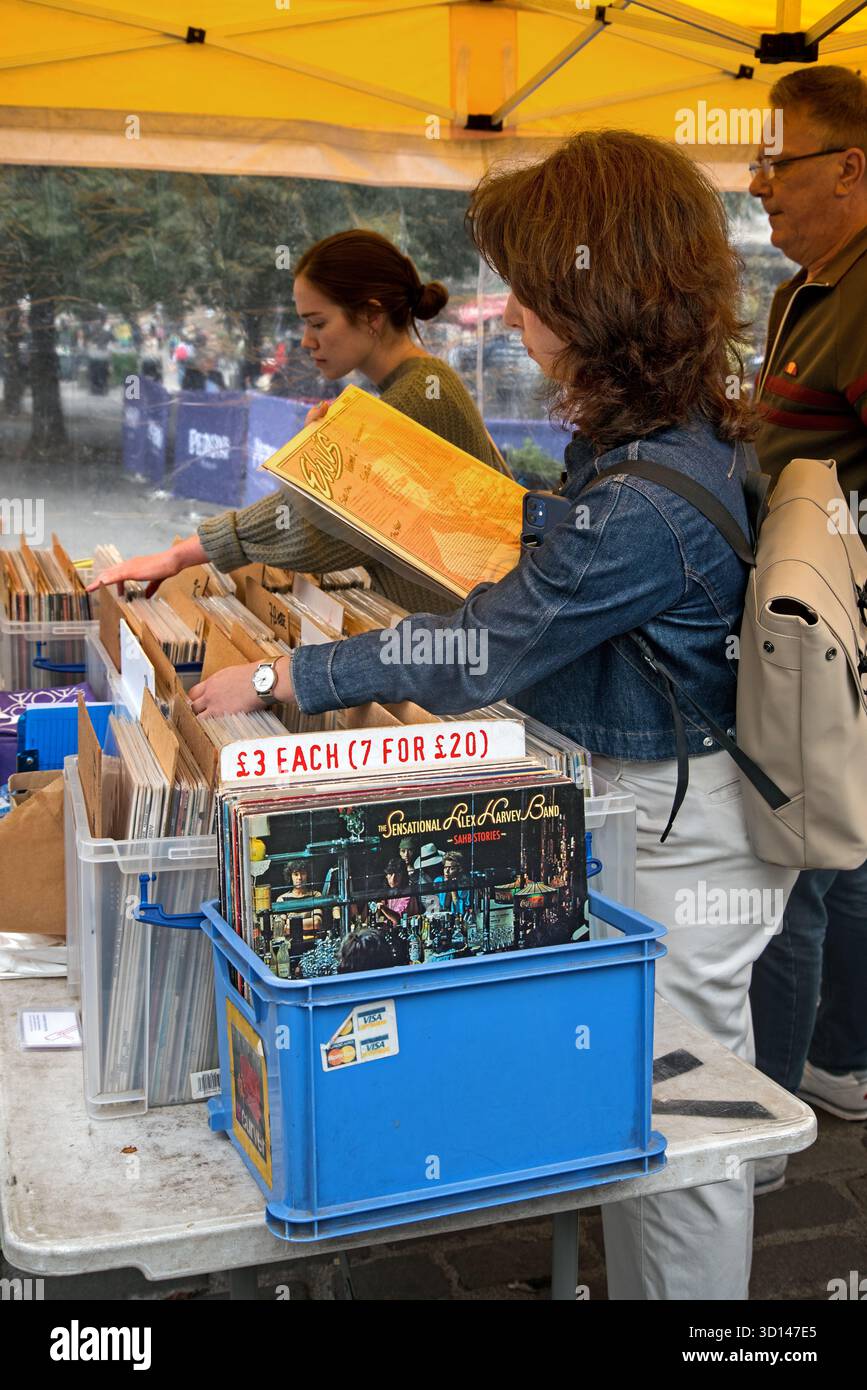 Young women browsing at a secondhand record stall in the Grassmarket ...