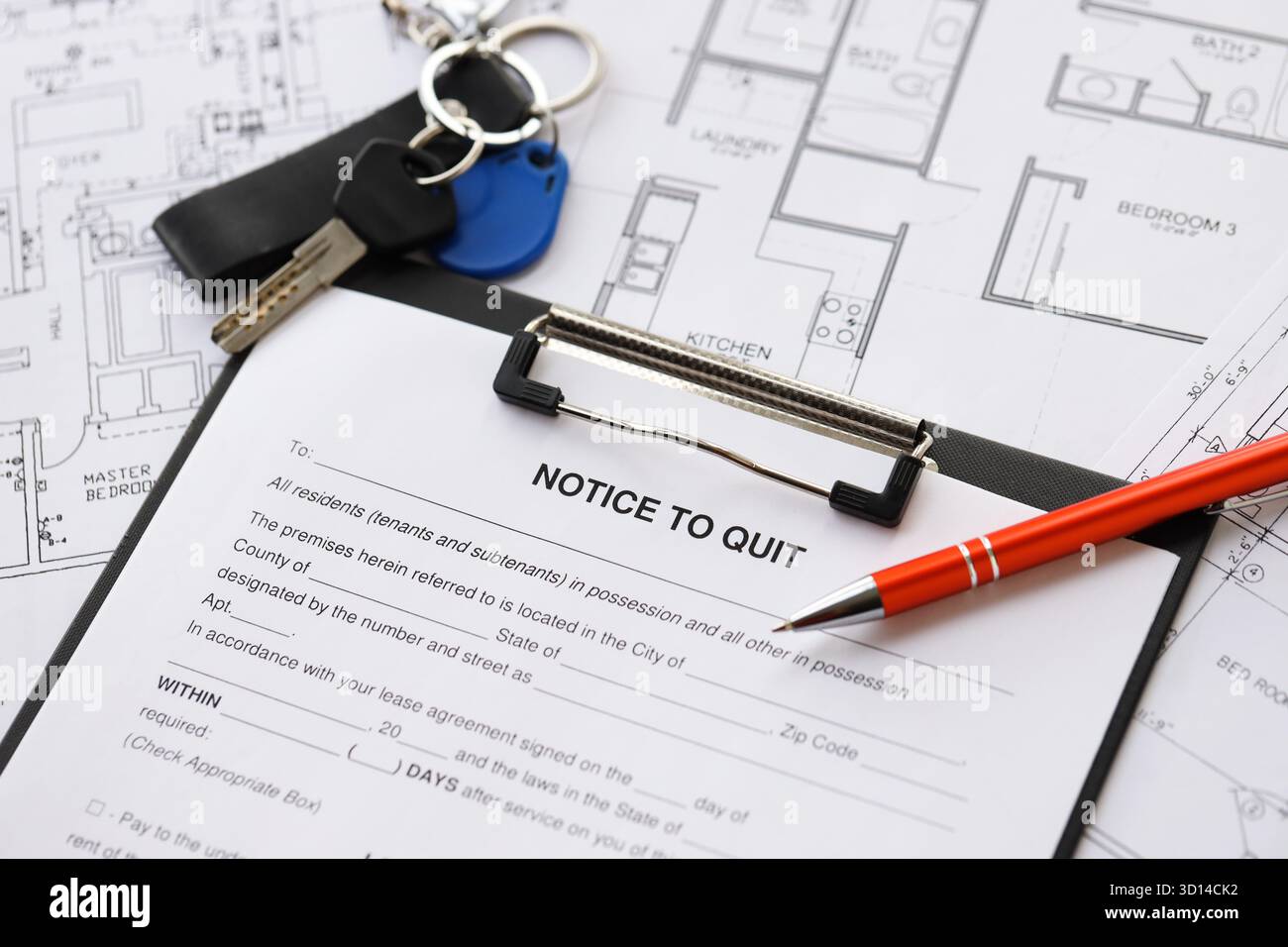 Pen and keys on Notice to quit form and planning blueprints of ...