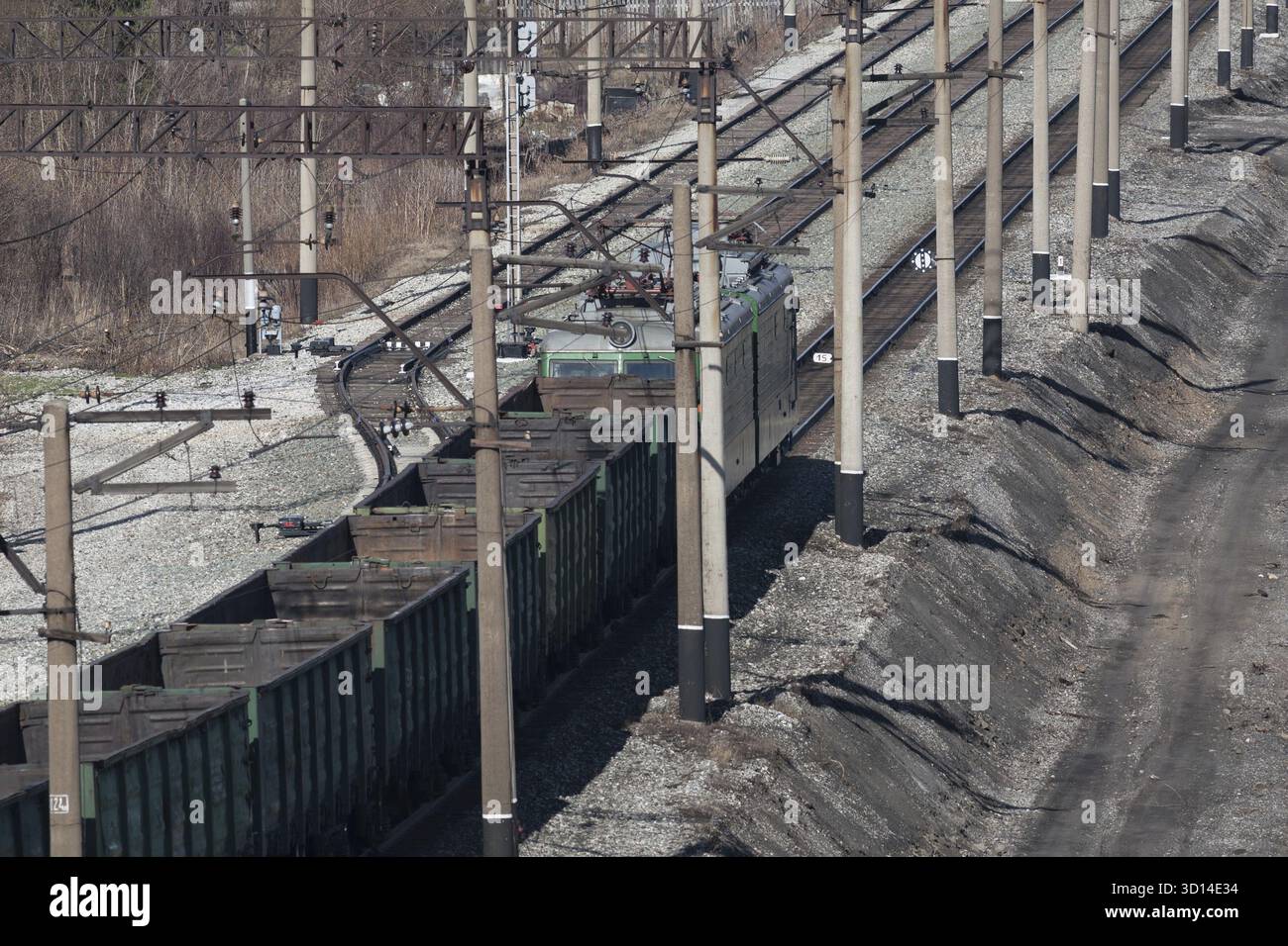 Electric locomotive pulls freight train with empty wagons Stock Photo ...