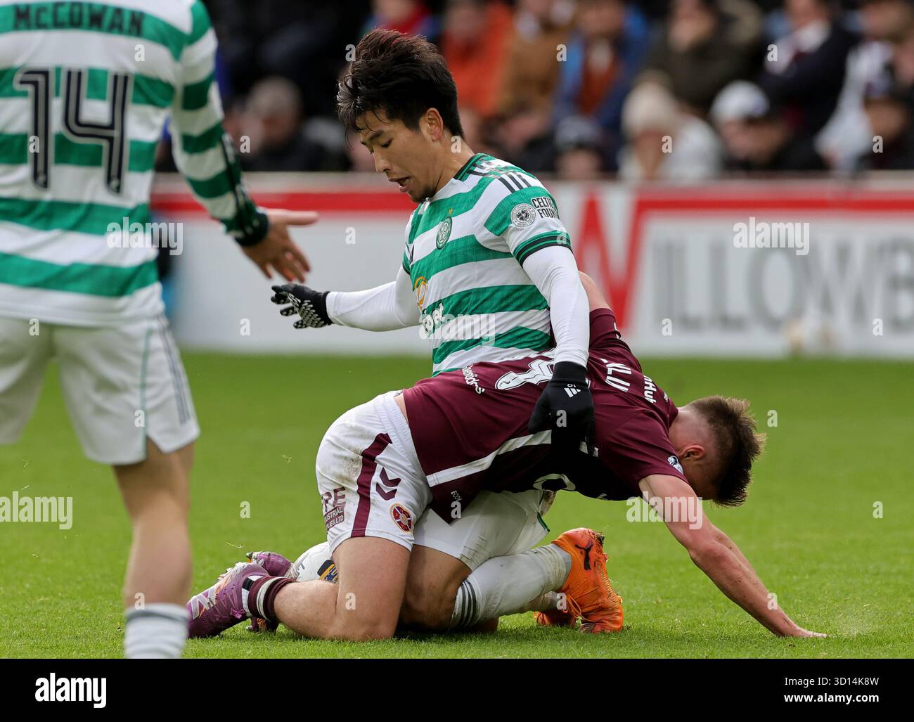 Celtic's Shin Yamada (top) and Heart of Midlothian's Cameron Devlin ...