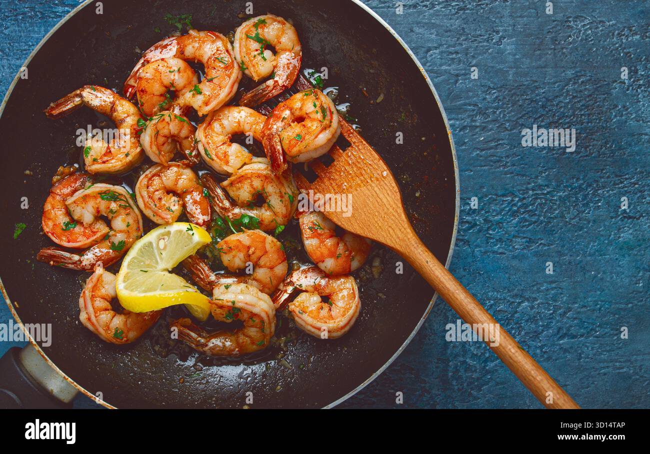 fried tiger prawns, jumbo, in garlic sauce, in butter, with herbs, in a ...