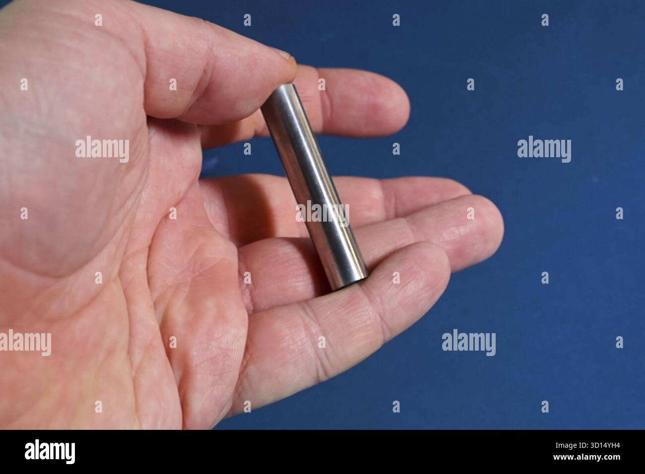 Tungsten rod in the hand. A piece of tungsten for experiments Stock ...