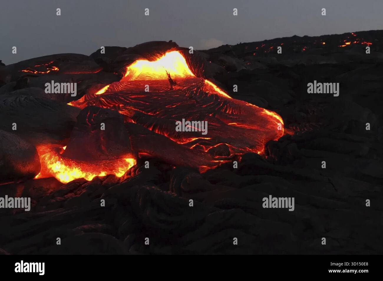 Pouring lava on the slope of the volcano. Volcanic eruption and magma ...