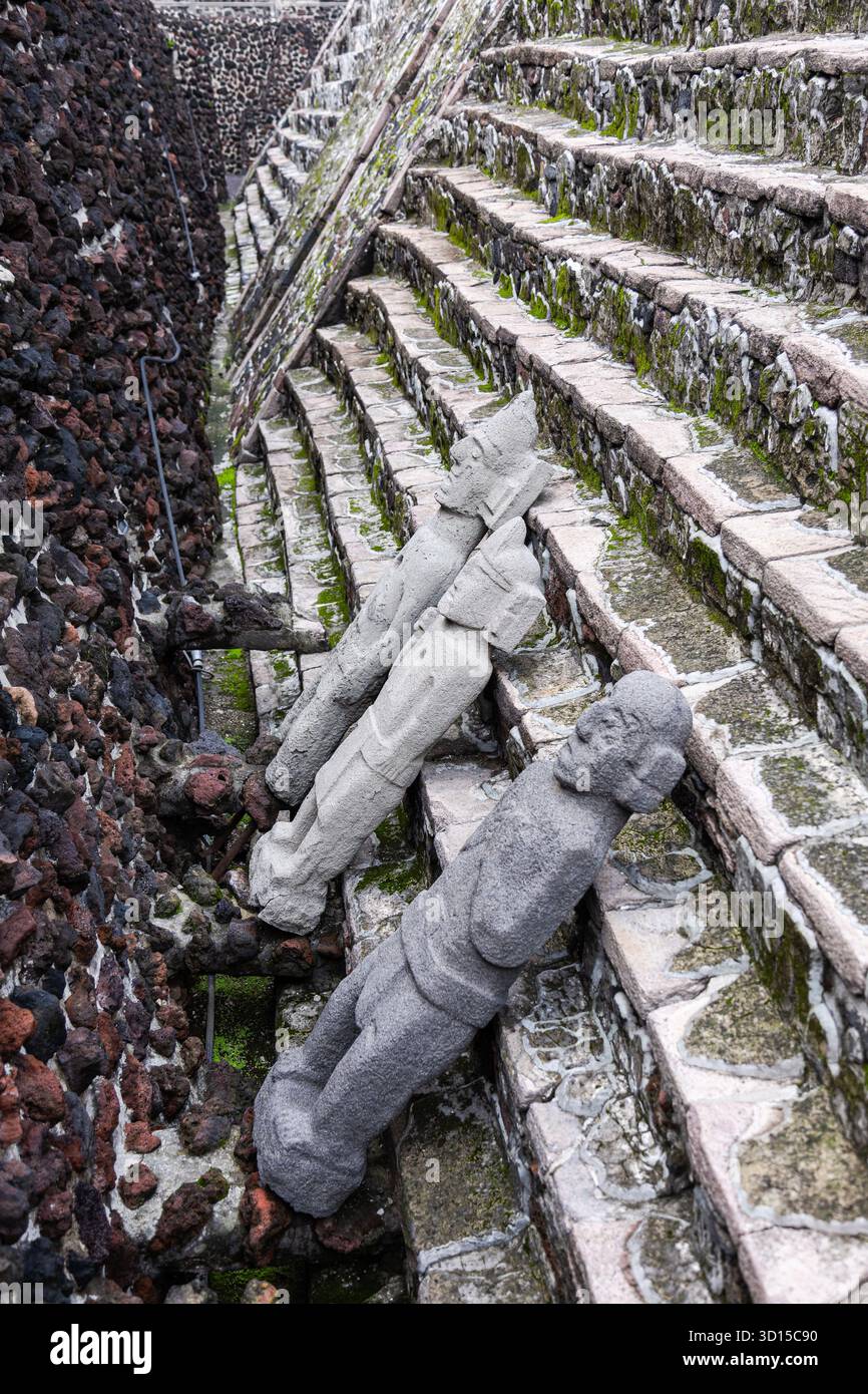 Sculptures possibly depicting Tlaloc, the rain god, placed on the steps ...