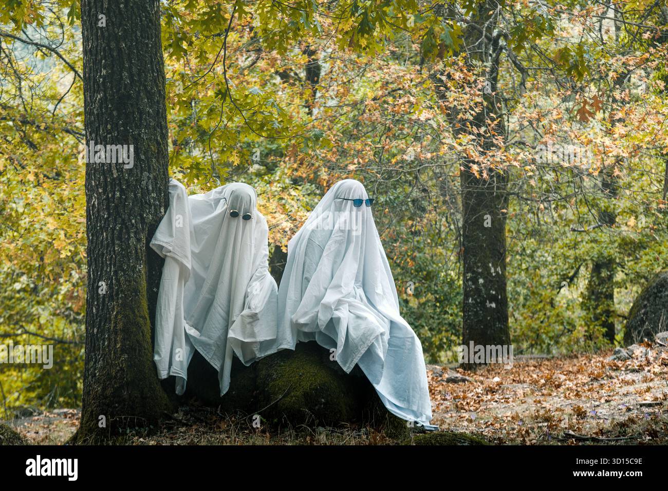 Ghost figures in white sheets haunting the forest Stock Photo - Alamy