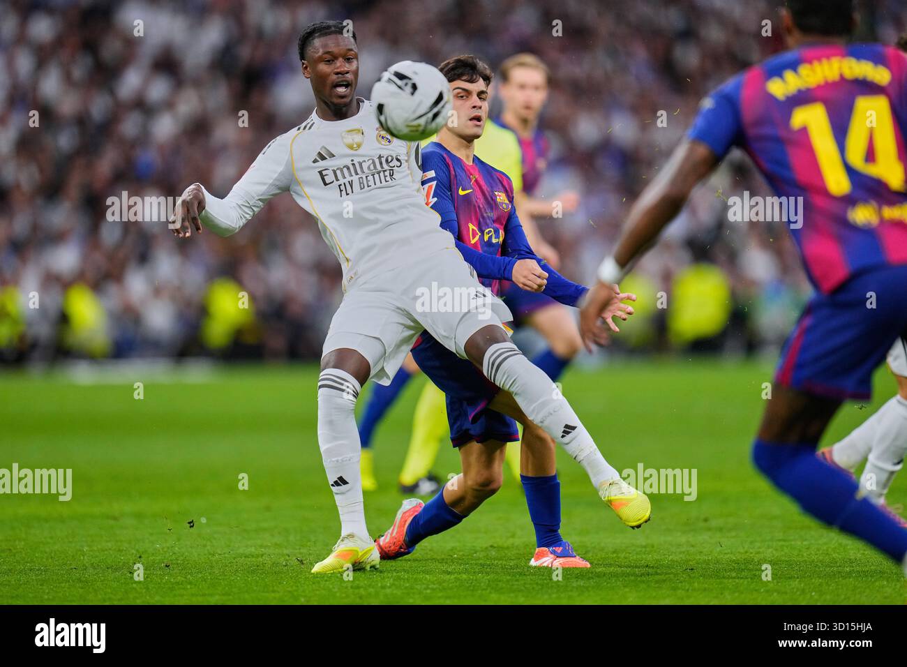 Real Madrid's Eduardo Camavinga, left, vies for the ball with Barcelona ...