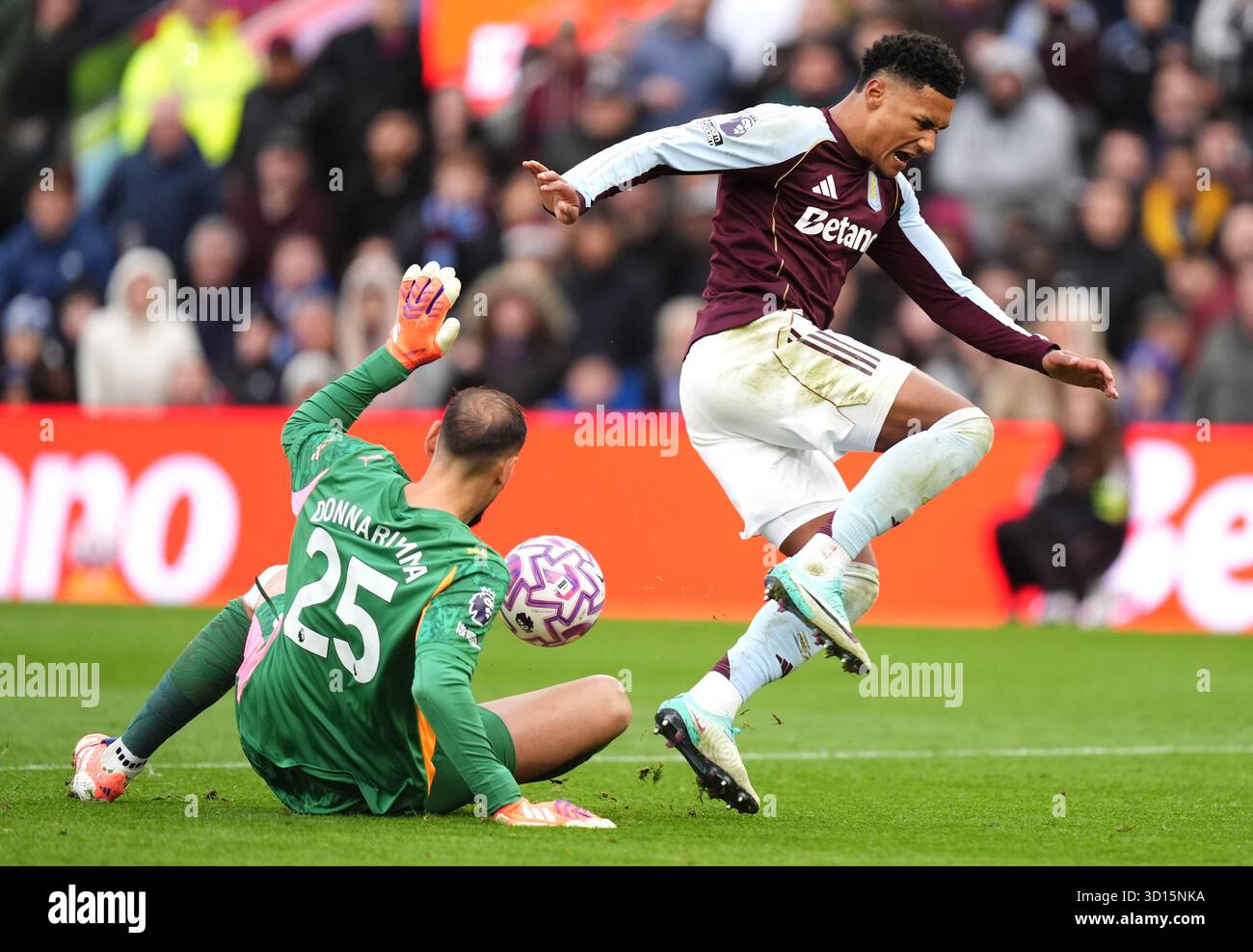 Aston Villa's Ollie Watkins (right) has his shot saved by Manchester ...
