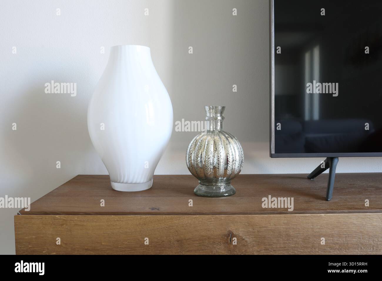 Two distinct decorative vases, a tall white ceramic style and a smaller ...