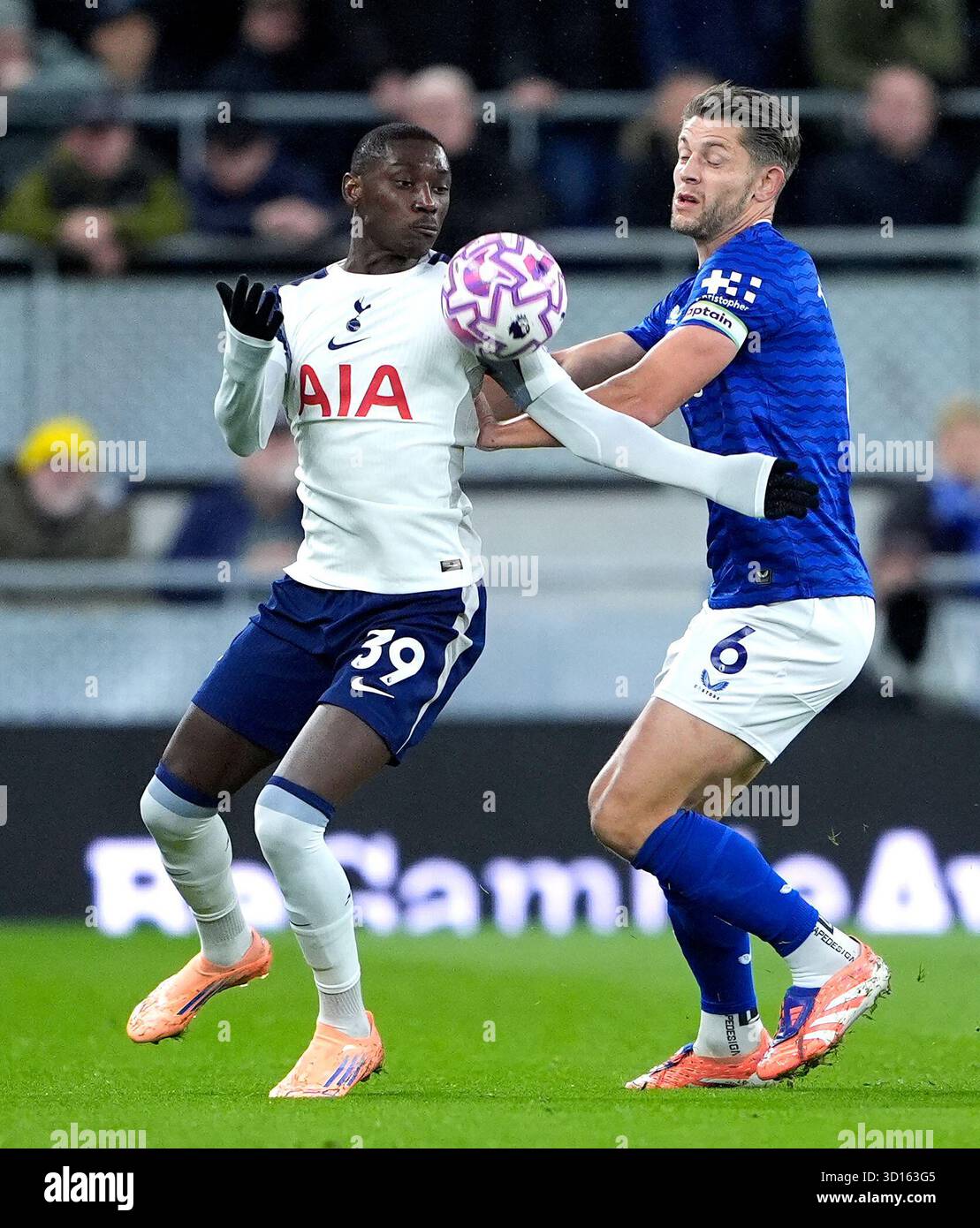 Tottenham Hotspur's Randal Muani (left) and Everton's James Tarkowski ...