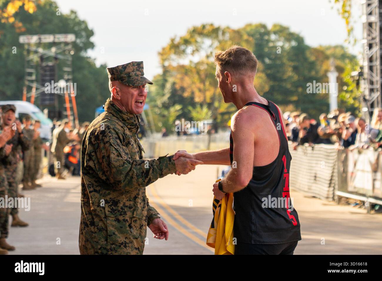 First place men's runner Kyle King shakes hands with a Marine after ...
