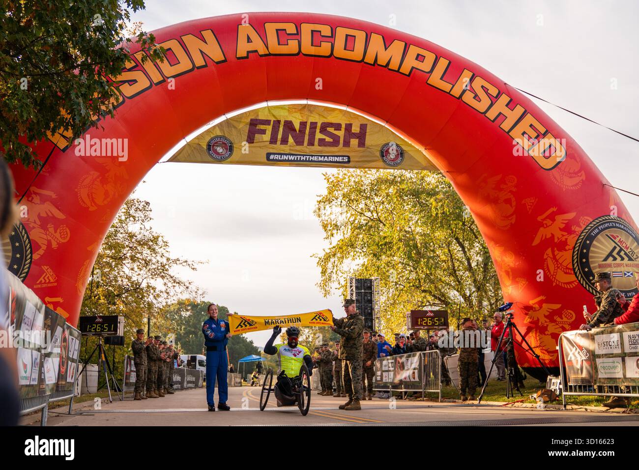 First place men's hand cyclist Anthony Robinson crosses the finish line ...