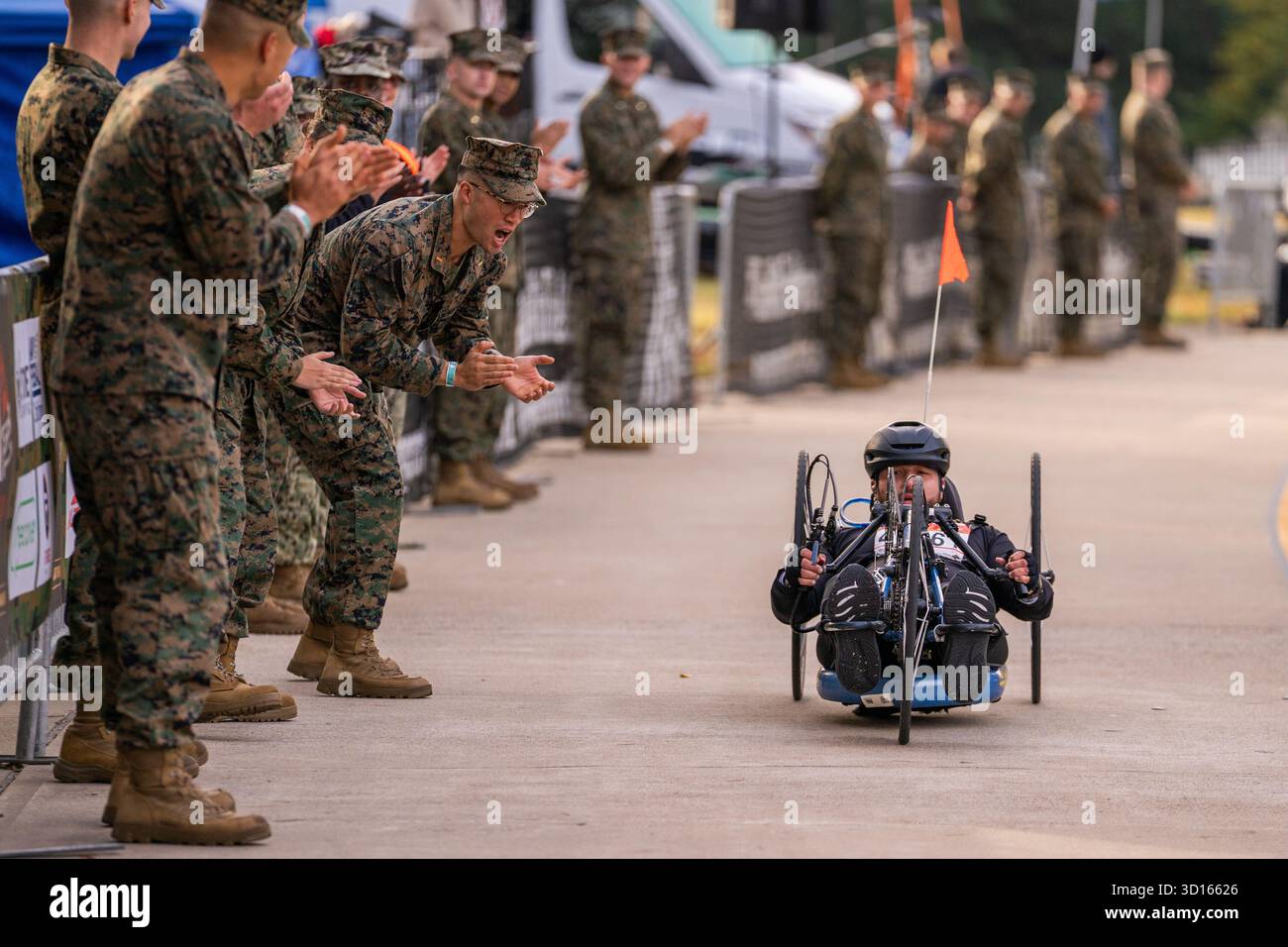 Marines cheer on a hand cyclist participating in the 50th annual Marine ...