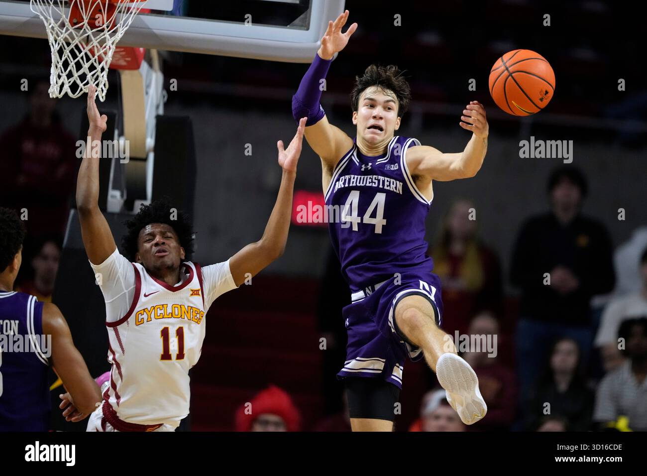 Northwestern guard Angelo Ciaravino (44) fights for a rebound with Iowa ...