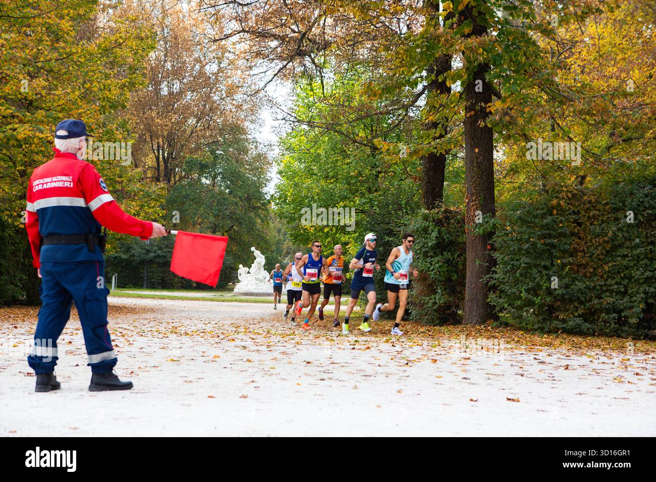 Event supervisor wearing uniform manages outdoor marathon signaling ...