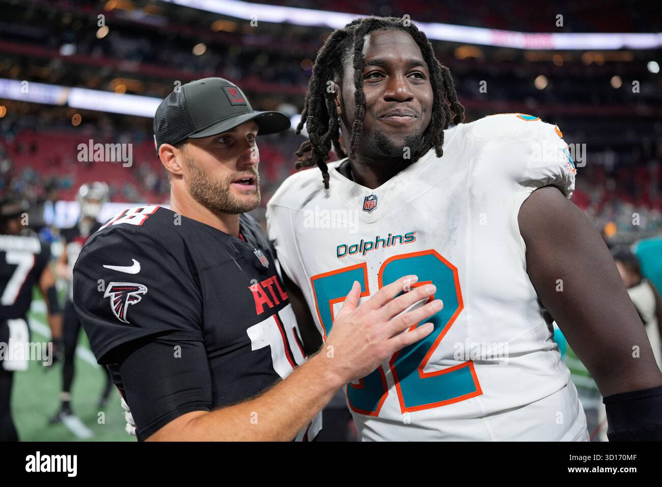 Atlanta Falcons quarterback Kirk Cousins (18) talks with Miami Dolphins ...