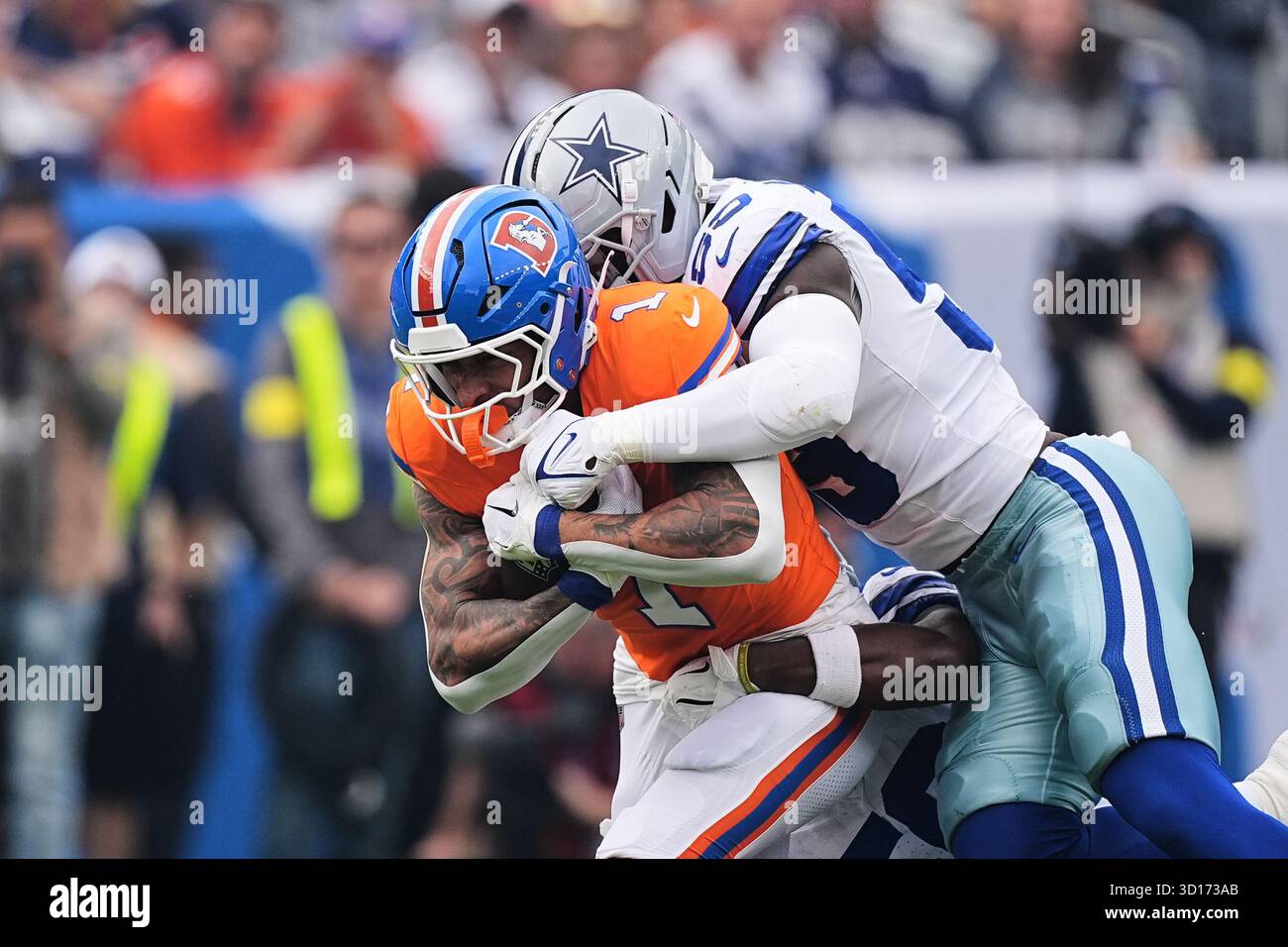 Denver Broncos tight end Evan Engram is stopped after catching a pass ...