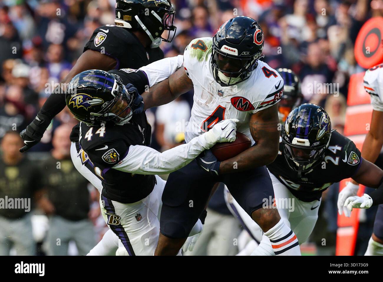 Chicago Bears running back D'Andre Swift (4) stiff arms Baltimore ...