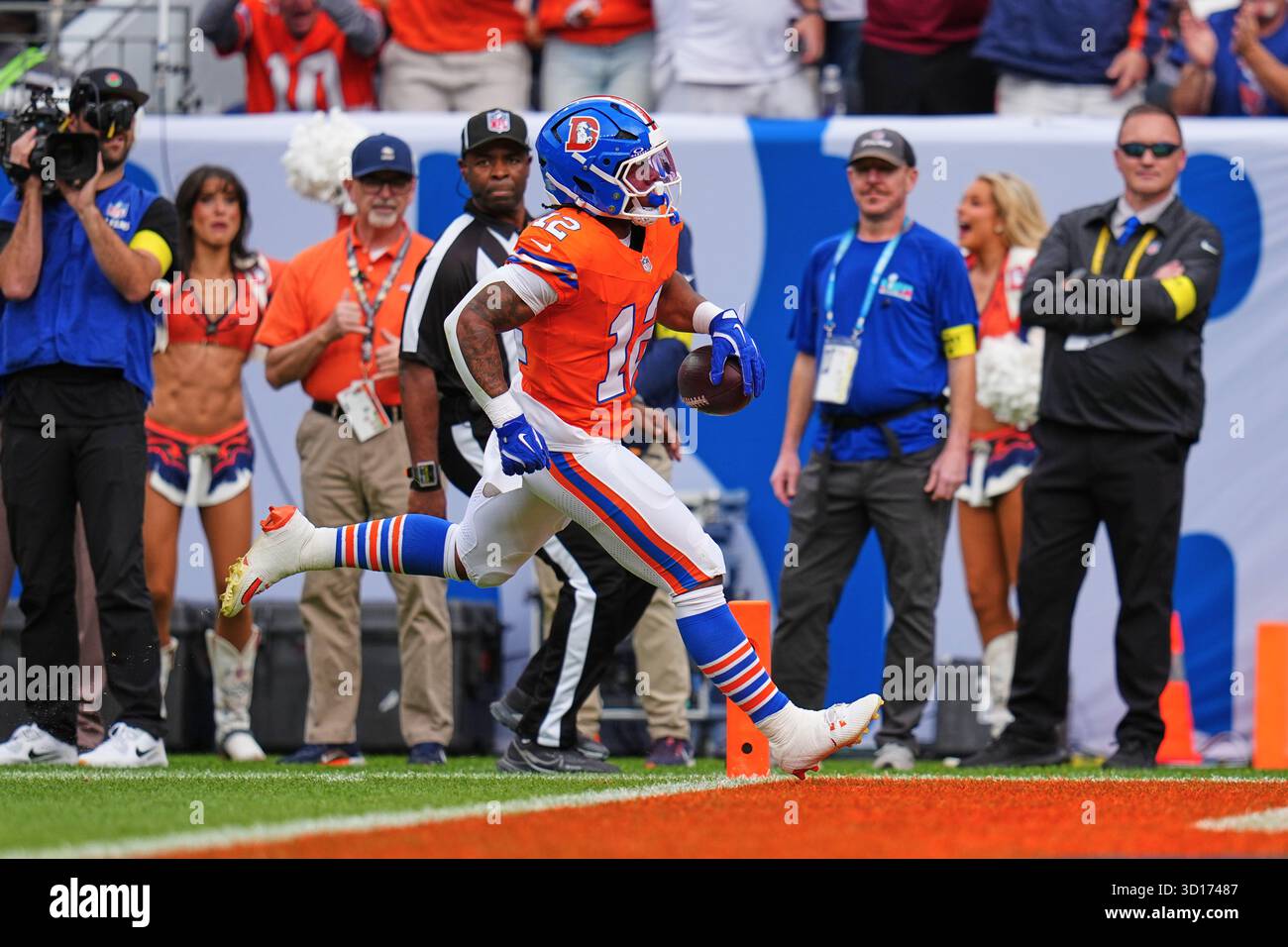 Denver Broncos' RJ Harvey scores a touchdown on a running play in the ...