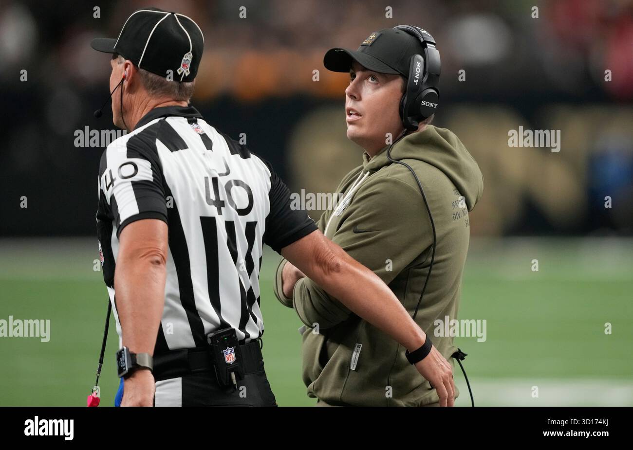 New Orleans Saints head coach Kellen Moore talks to line judge Brian ...