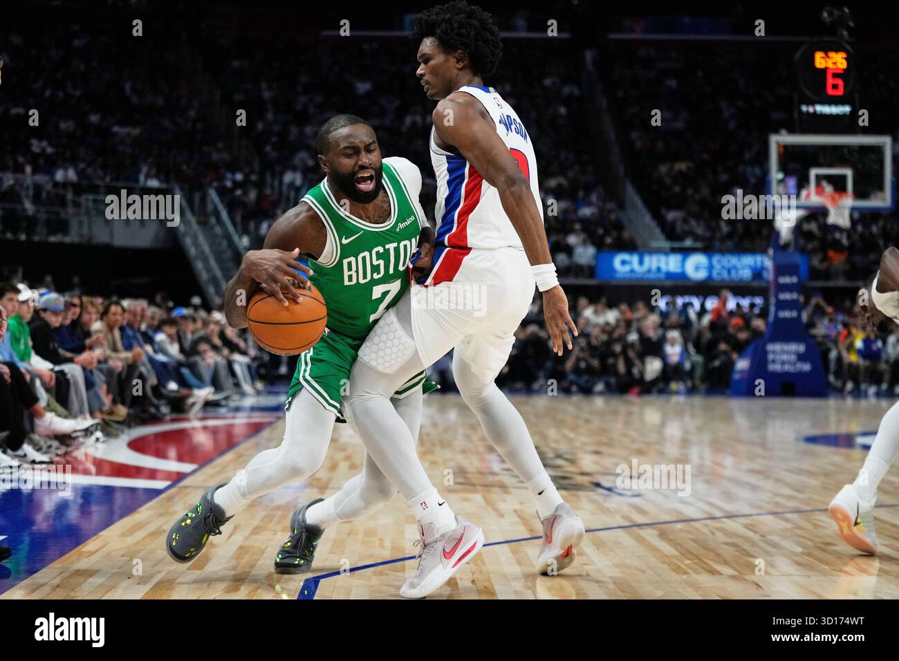 Boston Celtics guard Jaylen Brown, left, drives against Detroit Pistons ...