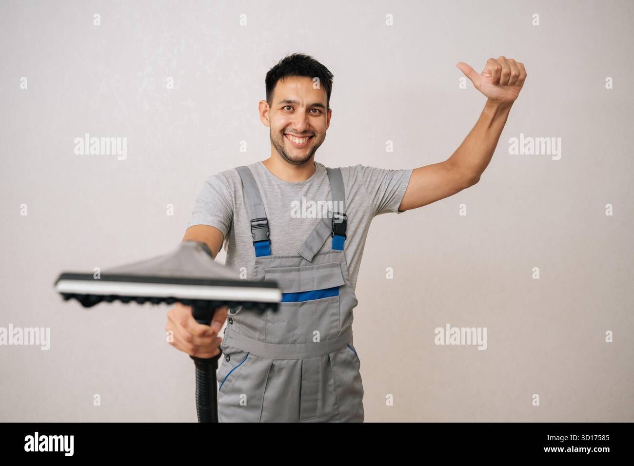 Studio portrait of friendly professional cleaning service employee in ...