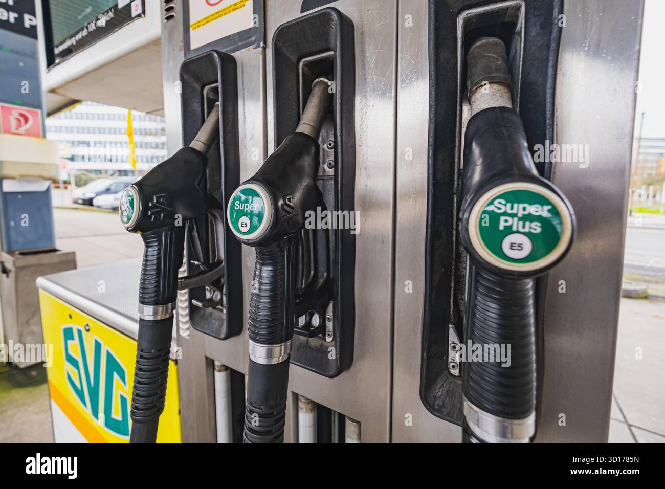 Close-up of fuel nozzles at a gas station, labeled Super, Super Plus E5 ...