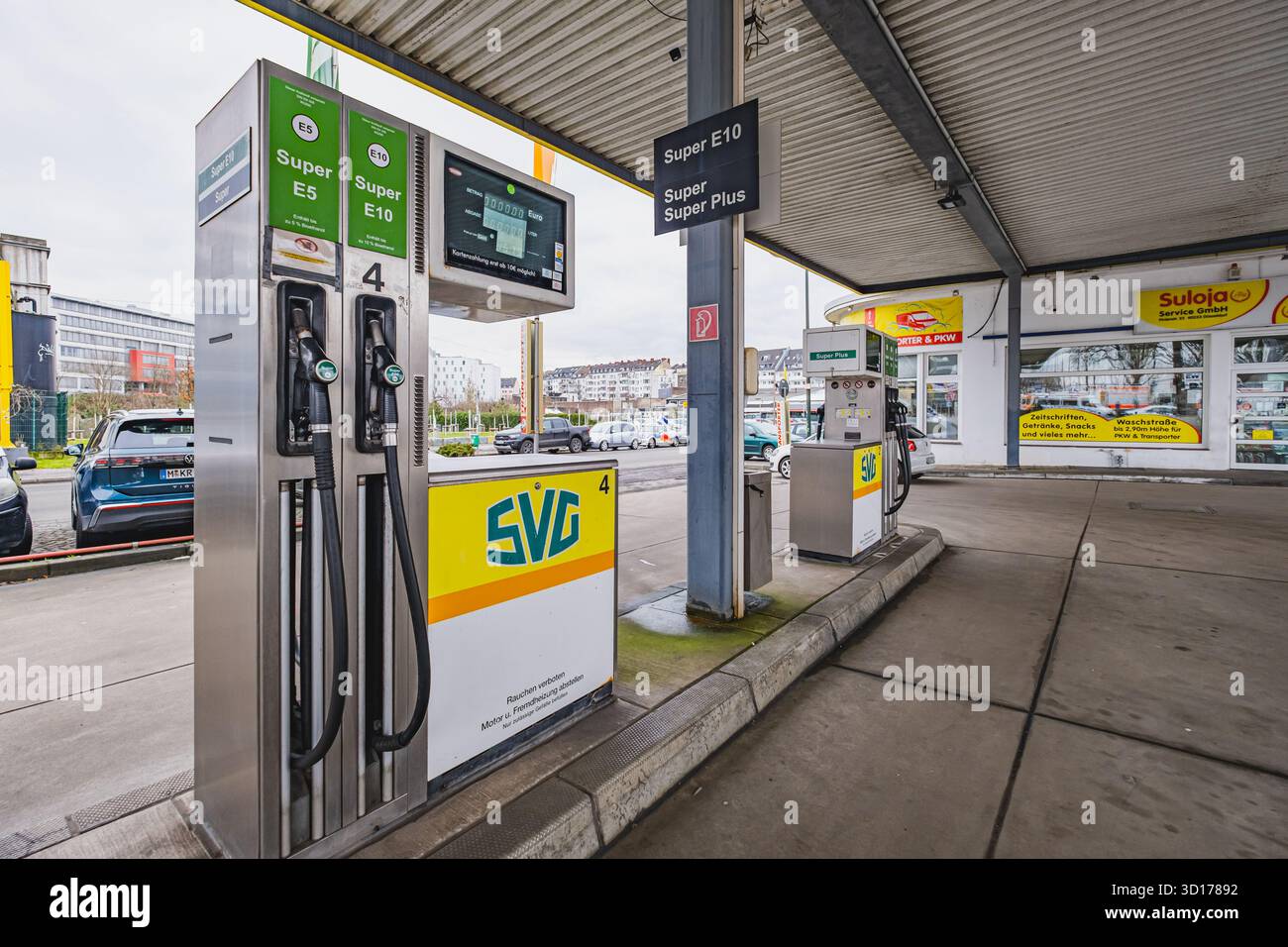 Modern fuel station with multiple pumps and cars in an urban setting ...