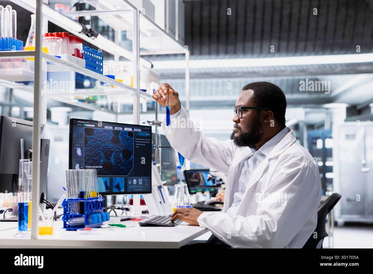 Quality control analyst using laboratory glassware filled with ...