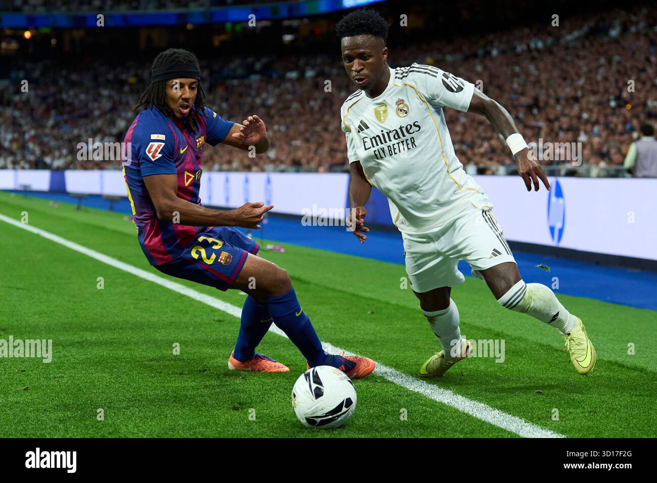 Vinicius Junior of Real Madrid CF battles for the ball with Jules ...