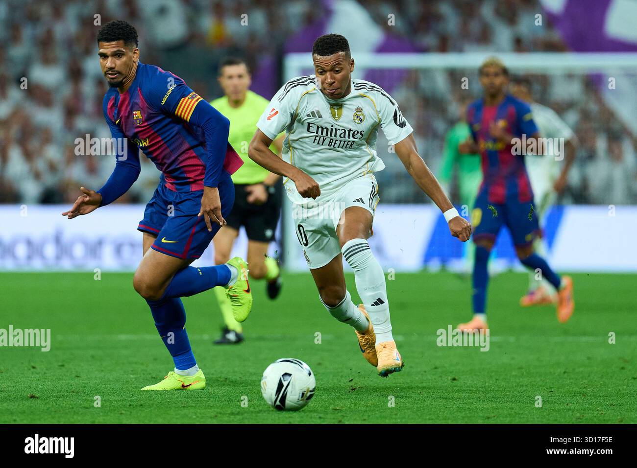 Kylian Mbappe of Real Madrid CF battles for the ball with Ronald Araujo ...