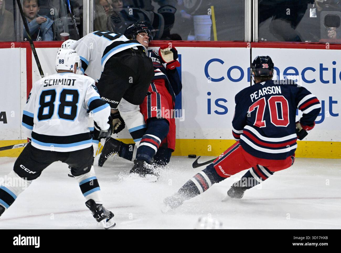Winnipeg Jets Morgan Barron, back right, is checked into the boards by ...